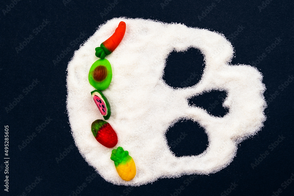 Unhealthy white sugar concept. Skull shape on a black background with a ...