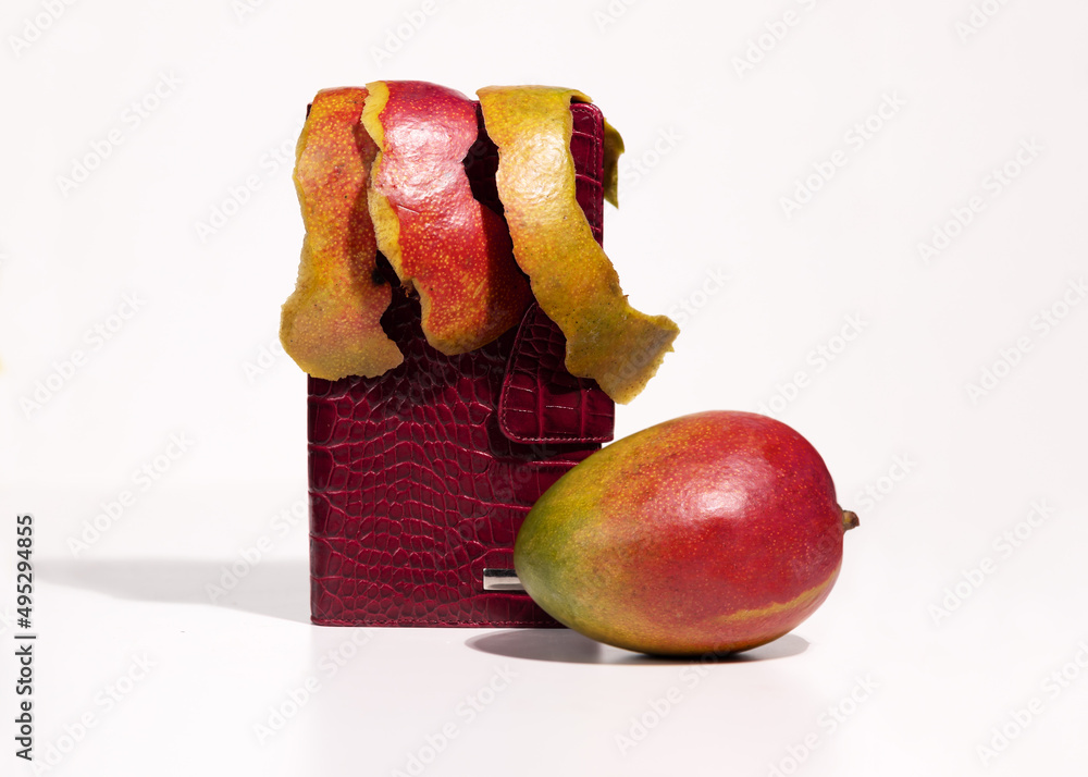 Red purse and mango fruit waste on white background. Vegan ...