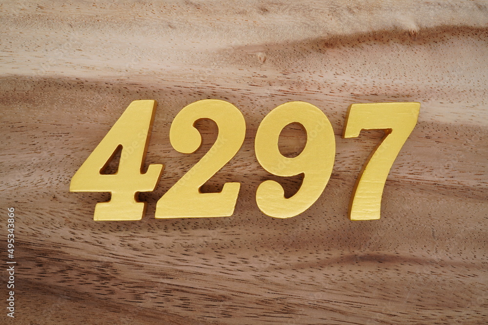 Poster Golden Arabic numerals on a real brown and white wooden floor ...