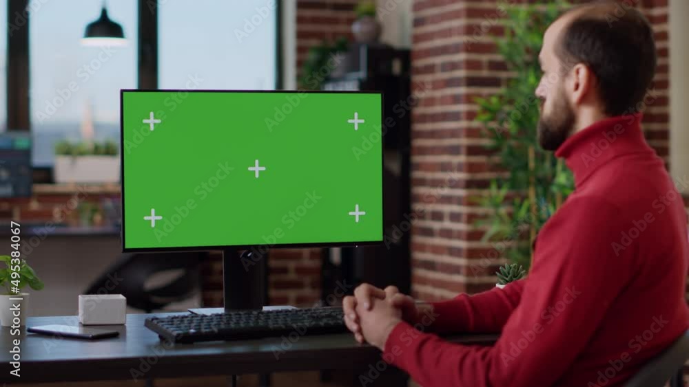 Male employee working with green screen on monitor, using technology at ...