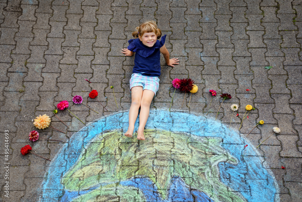 Little preschool girl with flowers and earth globe painting with ...