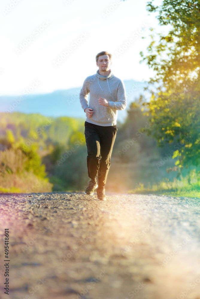 Running man jogging in rural nature at beautiful summer day. Sport ...