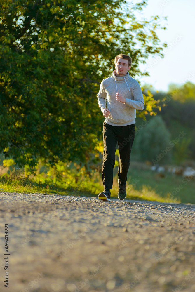 Running man jogging in rural nature at beautiful summer day. Sport ...
