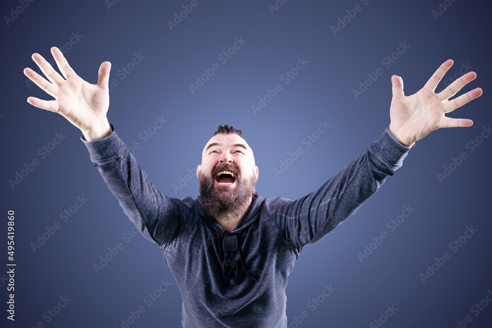 Menacing appearance. A man with a mohawk and dreadlocks stretches his ...