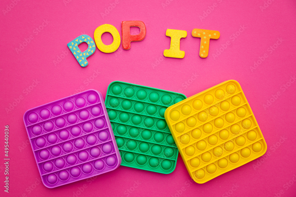 Sensory fidget toy "Pop-it". Instrument for fine motoric skils, tool to ...