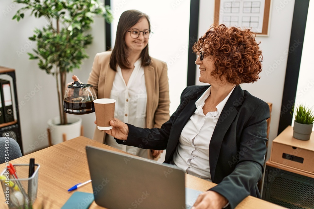 Group of two women working at the office. Mature woman and down ...