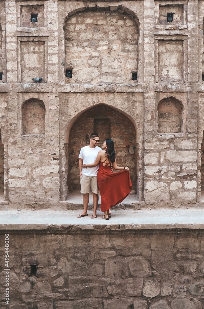 Foto de Woman in red dress hugging a man in Agrasen Ki Baoli historical ...