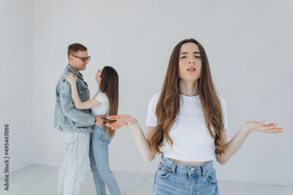 Love triangle. Loneliness. Young sad women standing while another women ...