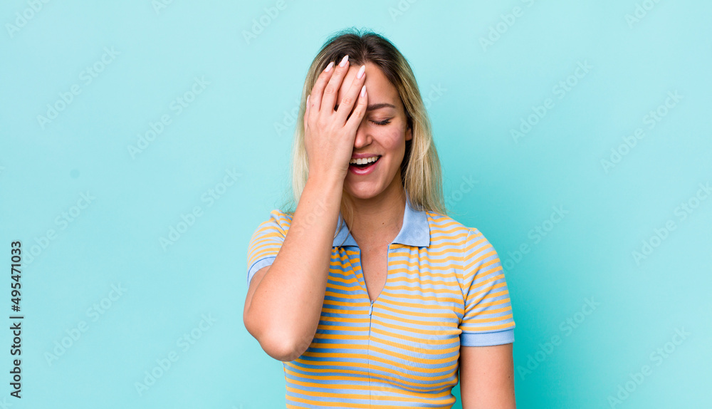 pretty blonde woman laughing and slapping forehead like saying d’oh! I ...