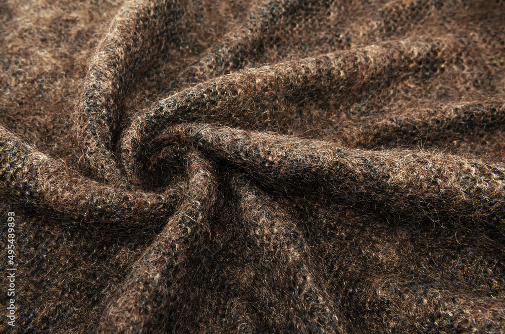 Twisted brown lambswool fabric with waves and curves. Wool material ...