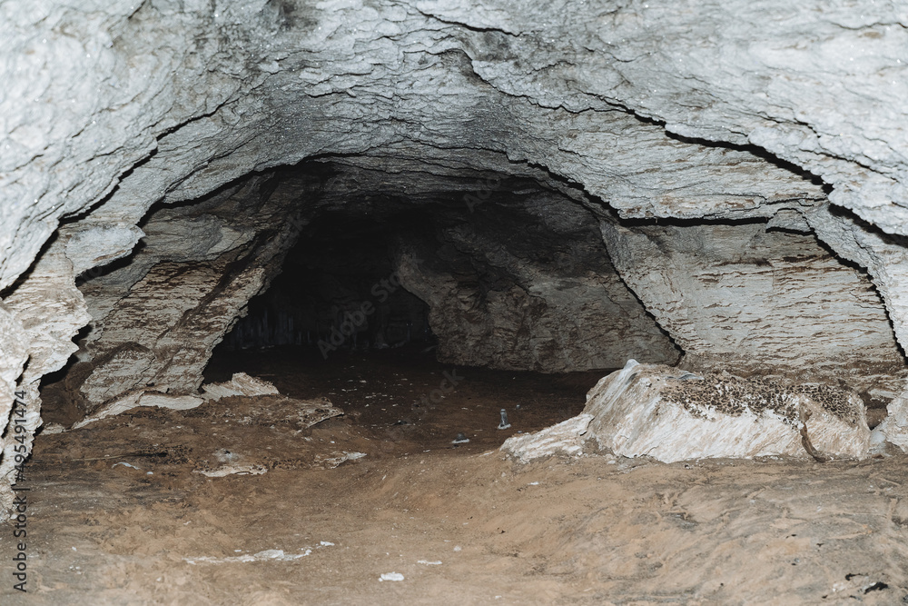 Passage underground in a stone cave, a karst cavity in the mountainside ...
