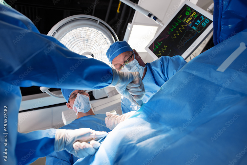 Medical operation with overhead light and patient monitors Stock Photo ...