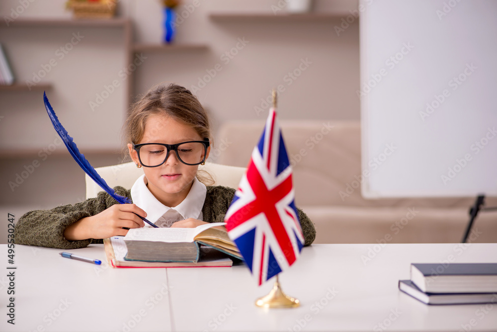 Young little girl studying english language at home Stock Photo | Adobe ...