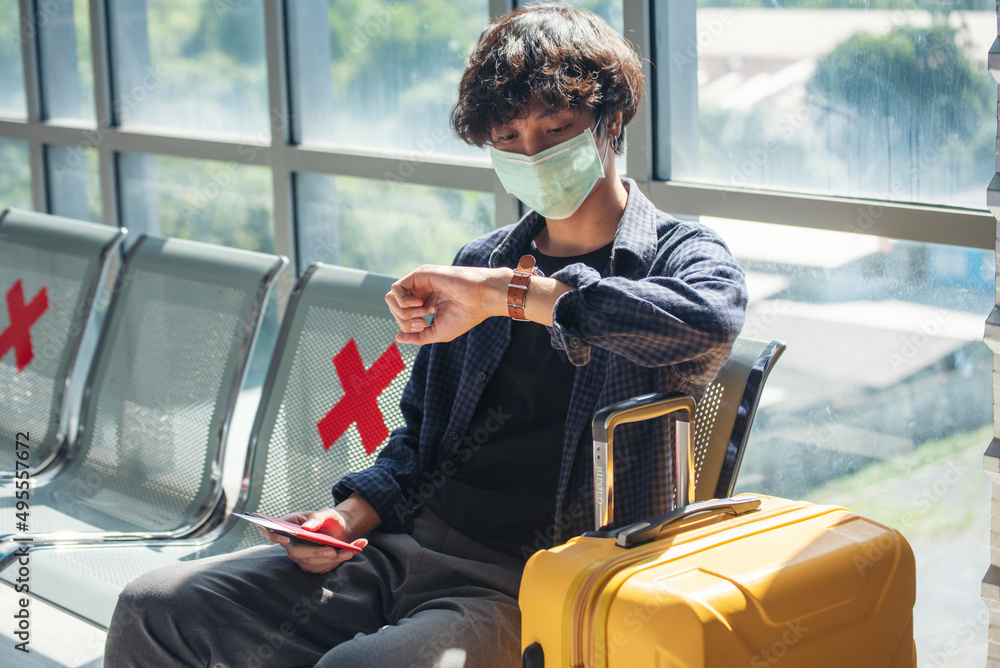 Asian young man traveller new normal wearing face mask sitting Social ...