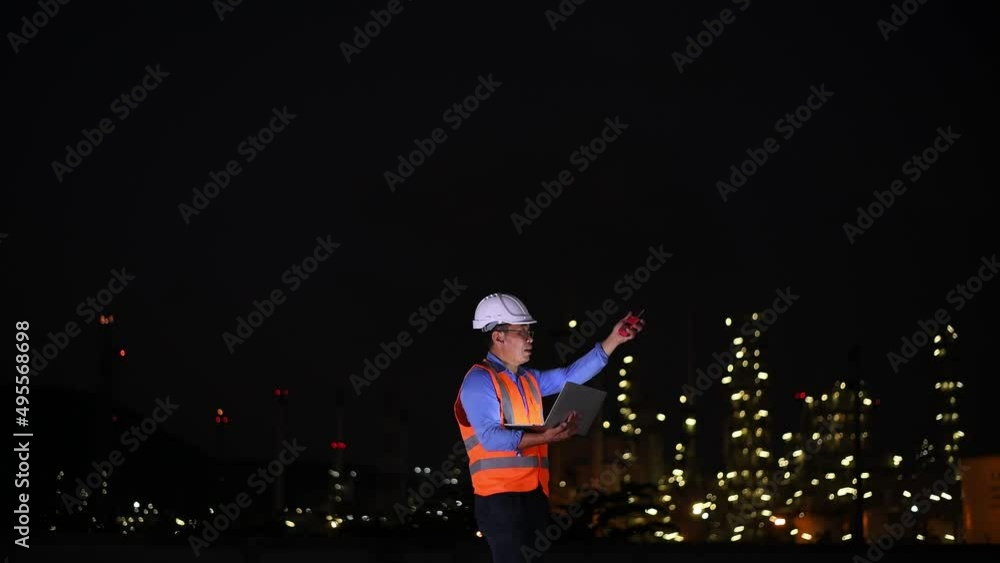 Engineer wearing uniform, white helmet and ear muff standing hand ...