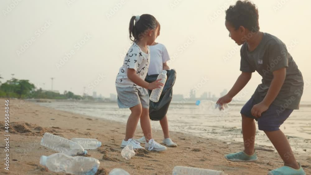 Volunteer happy family kids picking plastic bottle into trash plastic ...