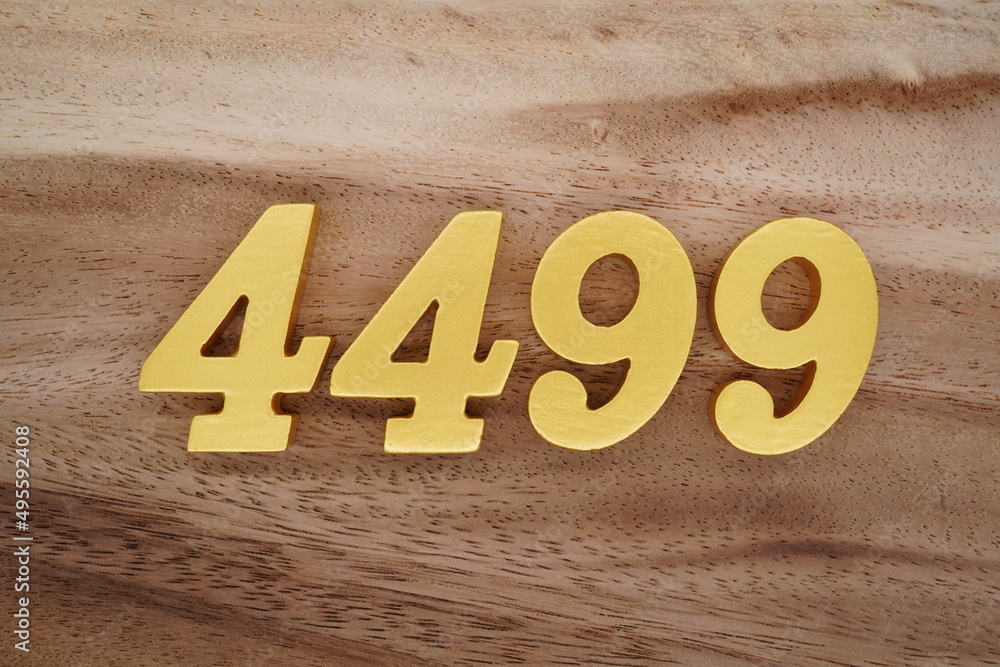 Golden Arabic numerals on a real brown and white wooden floor number ...