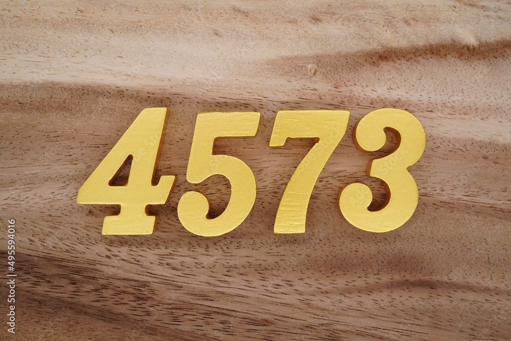 Golden Arabic numerals on a real brown and white wooden floor number ...