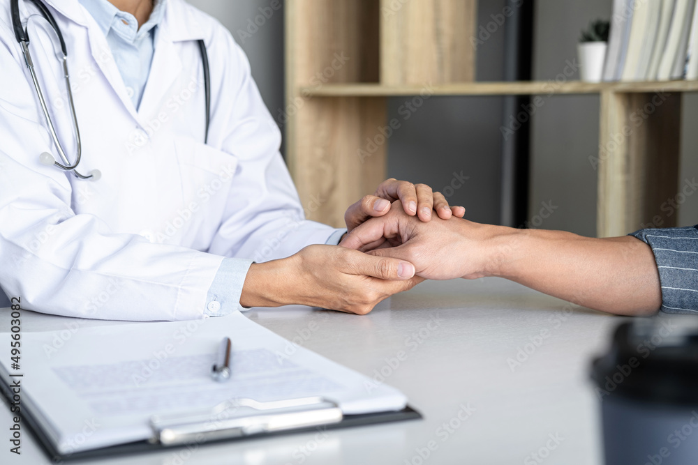 Close up of doctor touching patient hand for encouragement and empathy ...