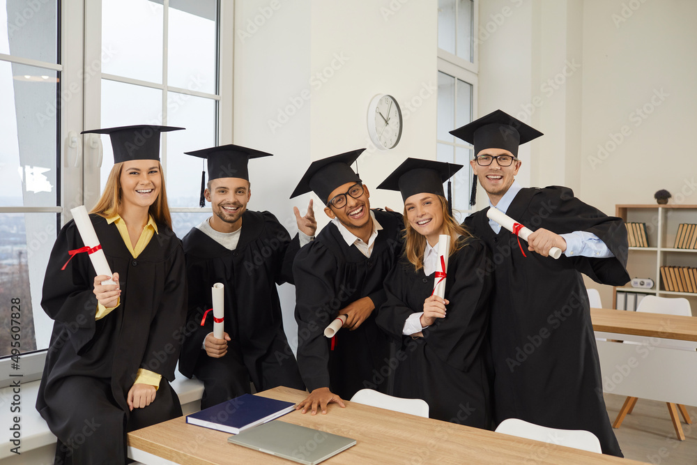 Group of happy university students on graduation day. Elated mixed race ...