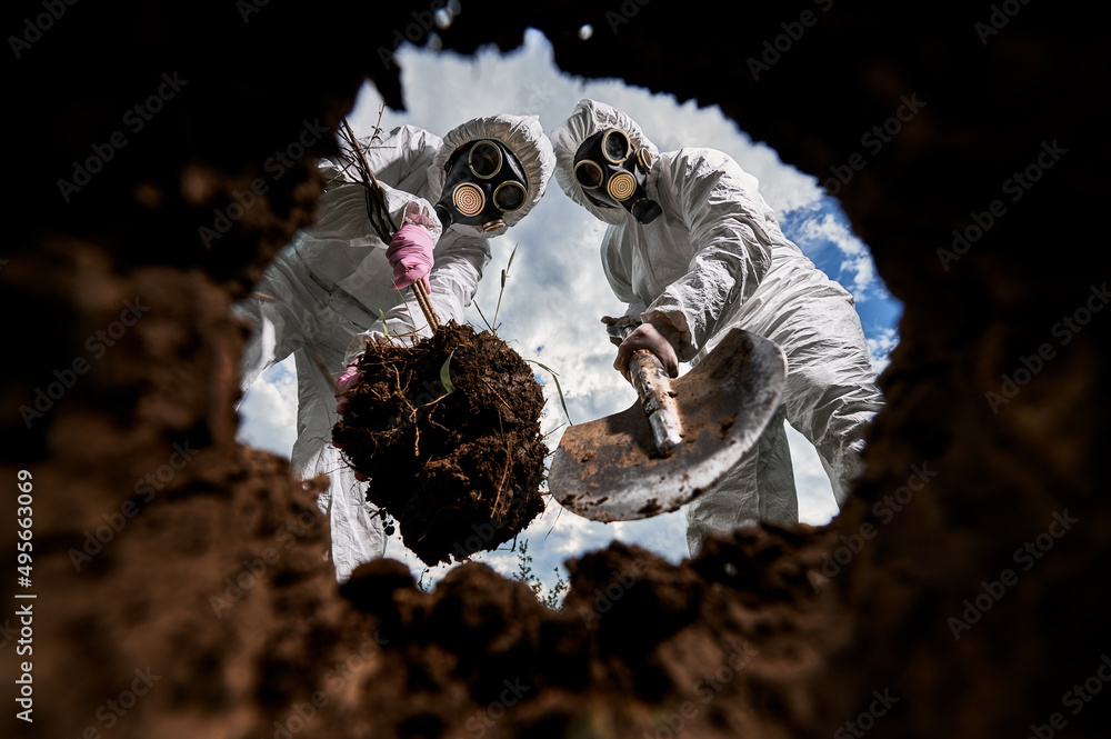 View from inside dug pit in which two people, completely protected from ...