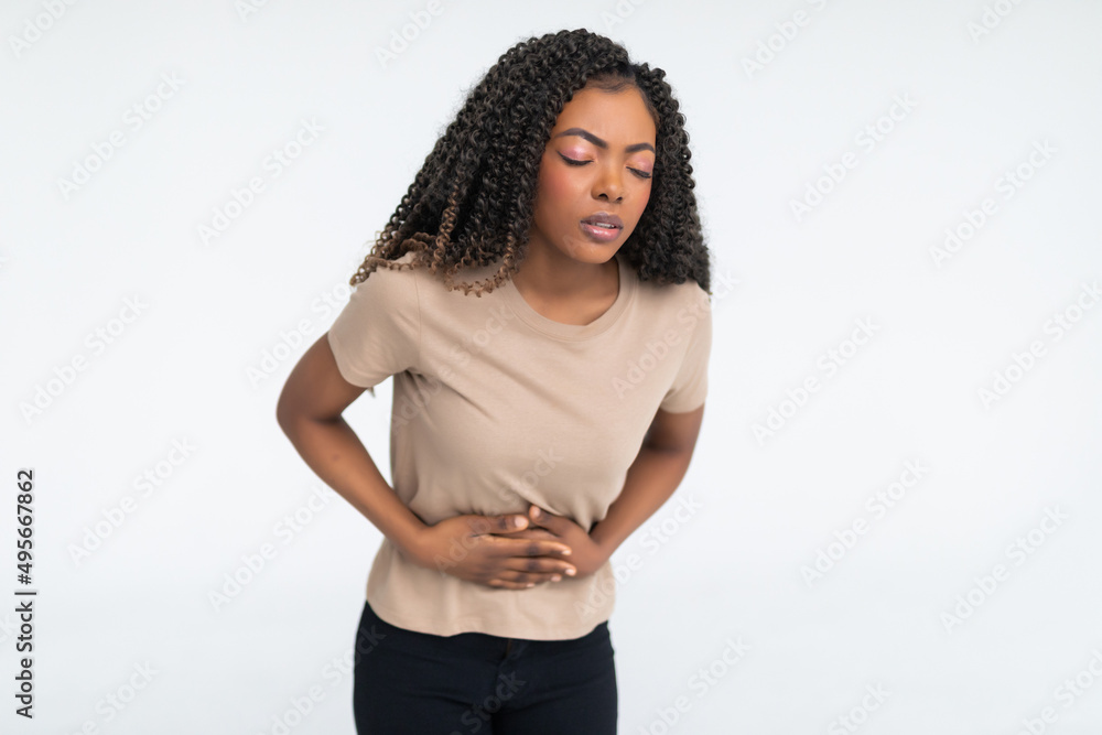 Closeup portrait of young, stressed woman, placing hands on stomach ...