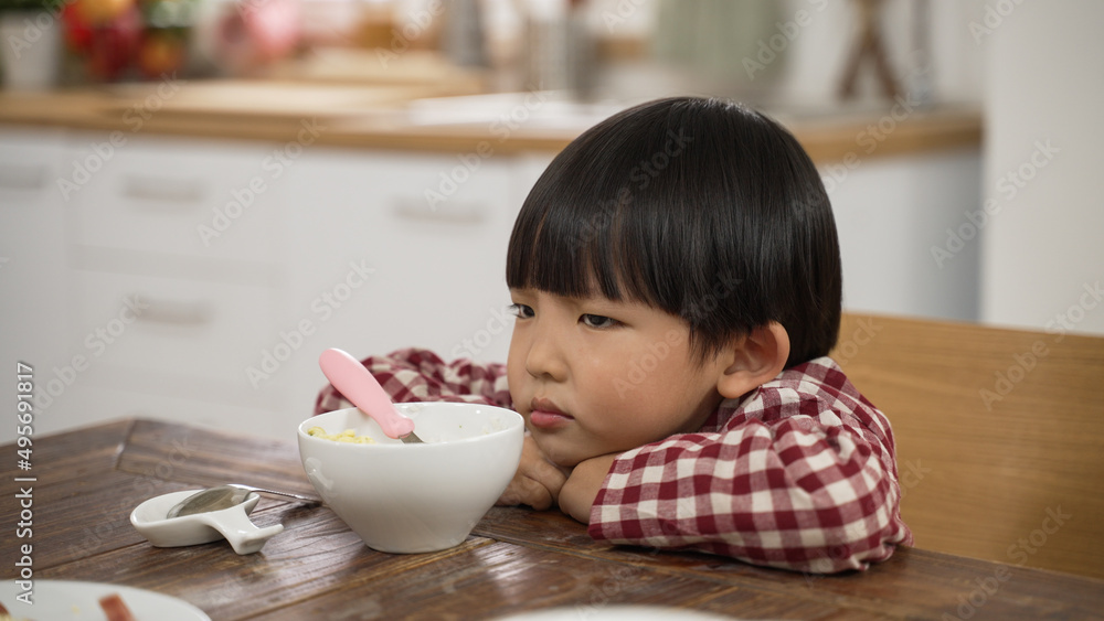 Foto de unhappy Asian little boy making a disgust expression while ...