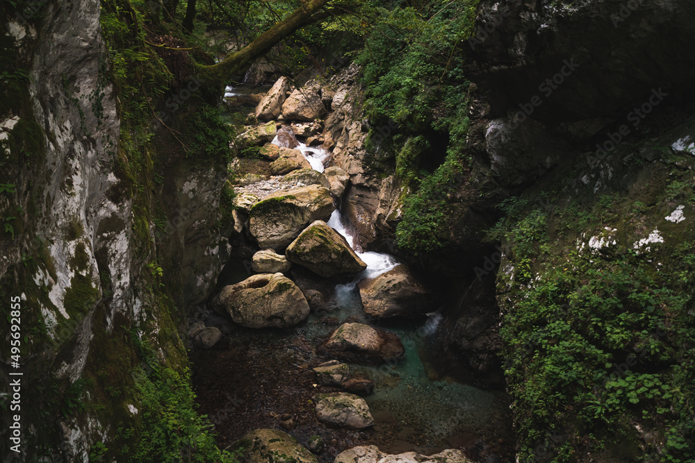 Beautiful scene of waterfall with streaming water over rocks surrounded ...
