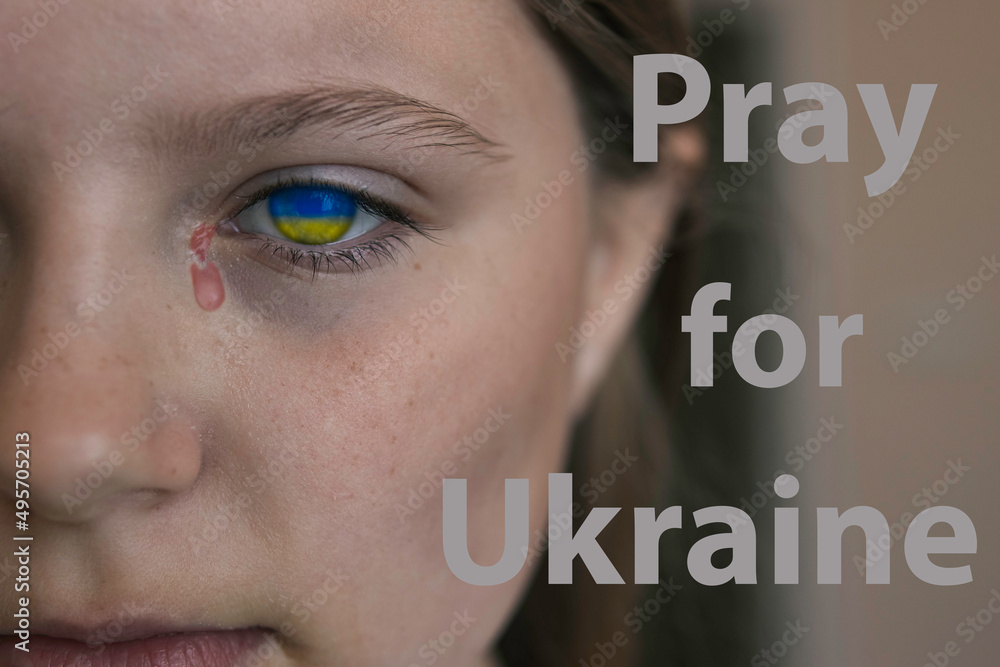 sad face of a child with the eyes of the flag of Ukraine and a tear ...