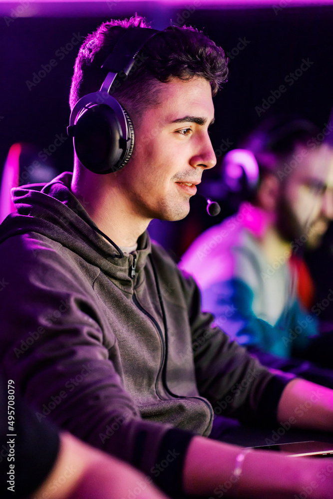Thrilled gamer winning video game while sits in gaming room. Stock ...