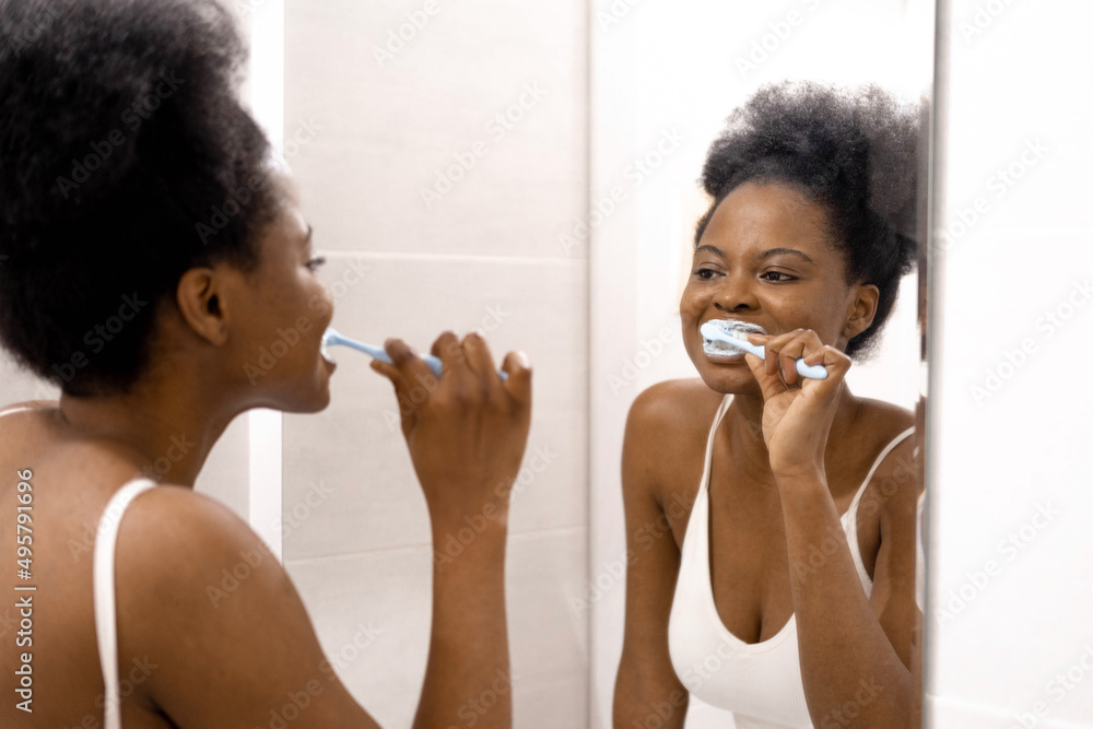 Portrait happy black African American girl brushing teeth in the ...