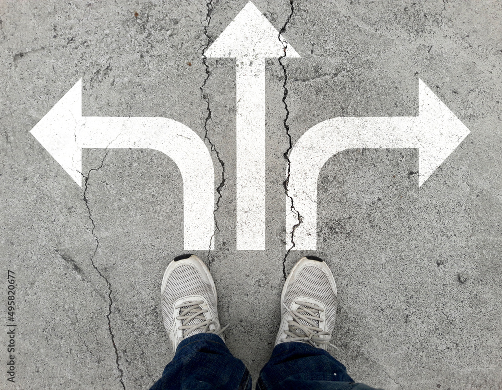 Shoes and arrows pointing in different directions on the road Stock ...