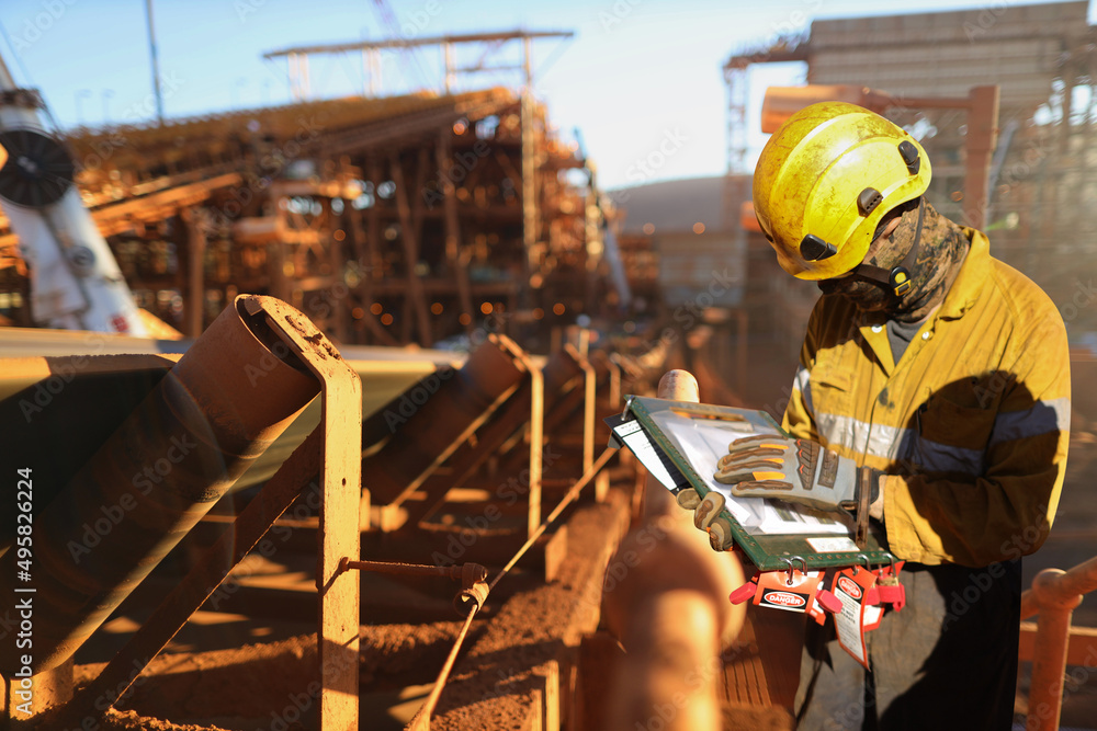 Safety supervisor wearing safety helmet verifying holding isolation ...