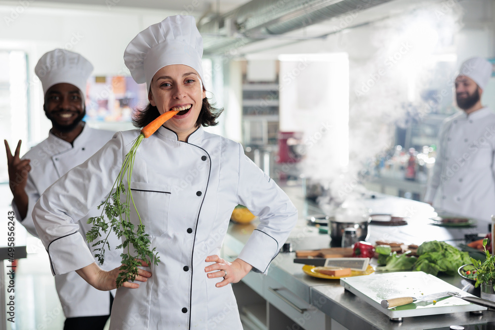 Funny playful head chef having carrot between teeth acting goofy and ...