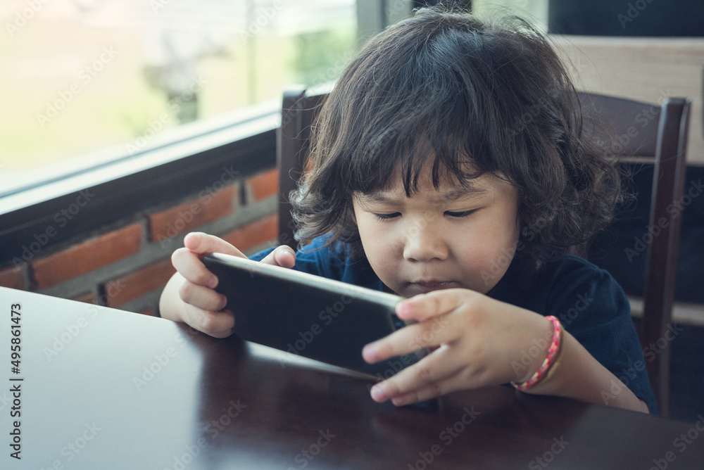 Child smartphone addiction. Stock Photo | Adobe Stock
