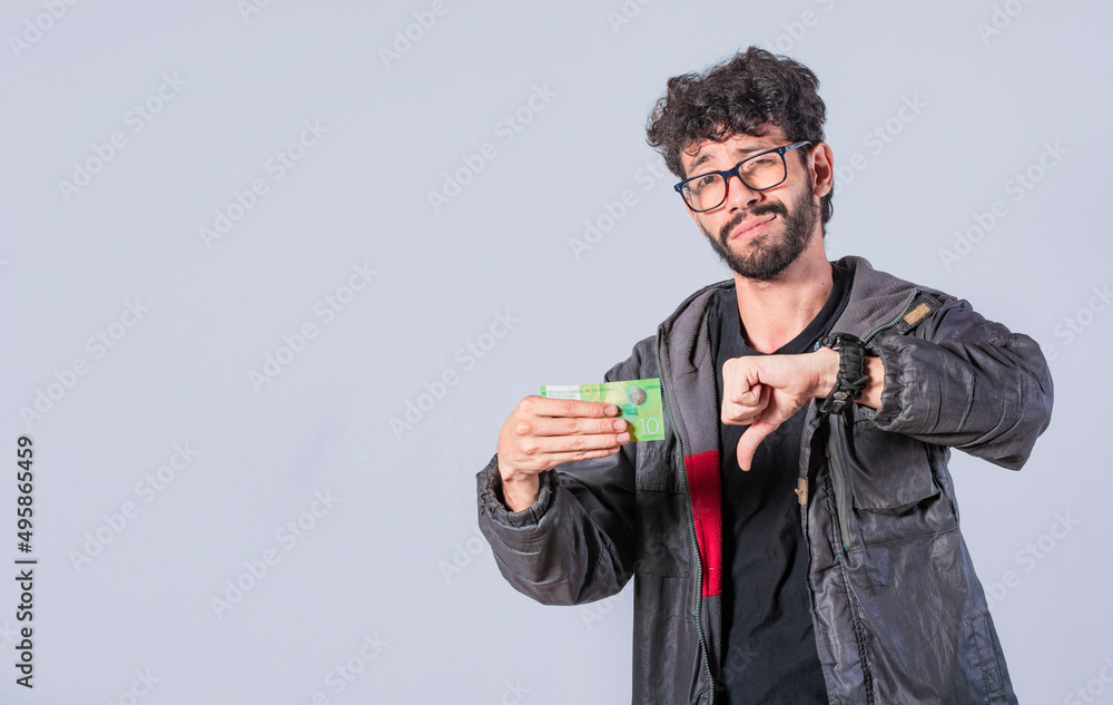 Foto de Sad man holding banknote, Sad man with a banknote with thumb ...