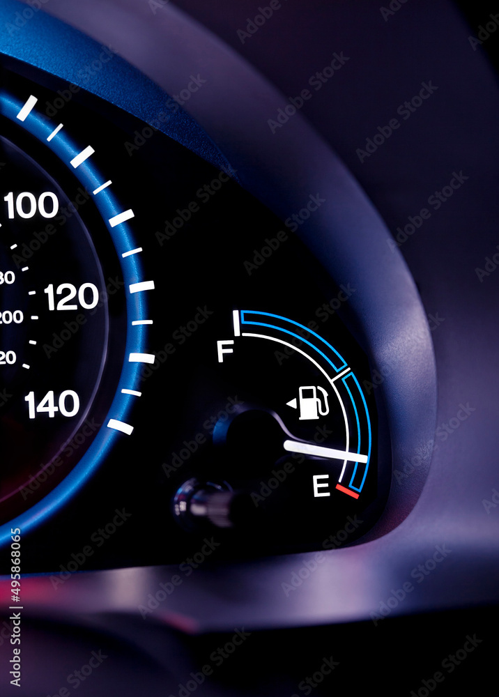 A car interior, the dashboard,instrument panel,and fuel gauge. A ...