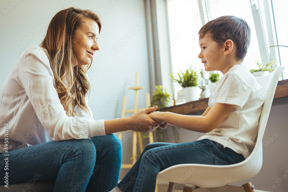 Young Boy Talking With Counselor At Home. Female psychologist working ...