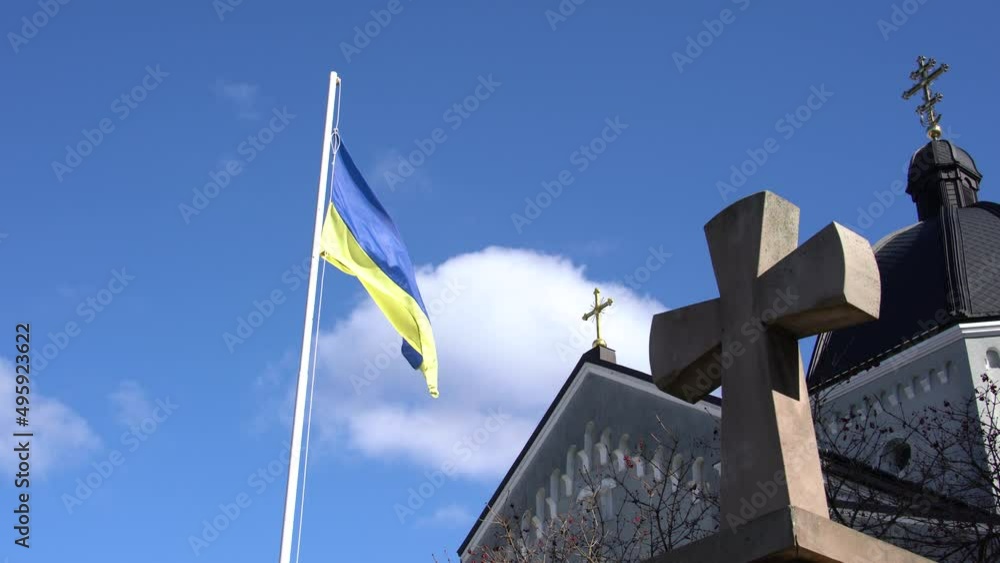 The flag of Ukraine on a metal flagpole flutters in the wind in the ...