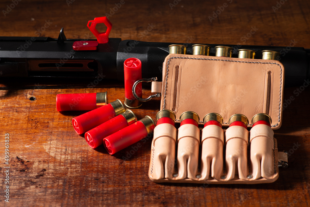 black body and barrel automatic shotgun with red slide and safety flag ...