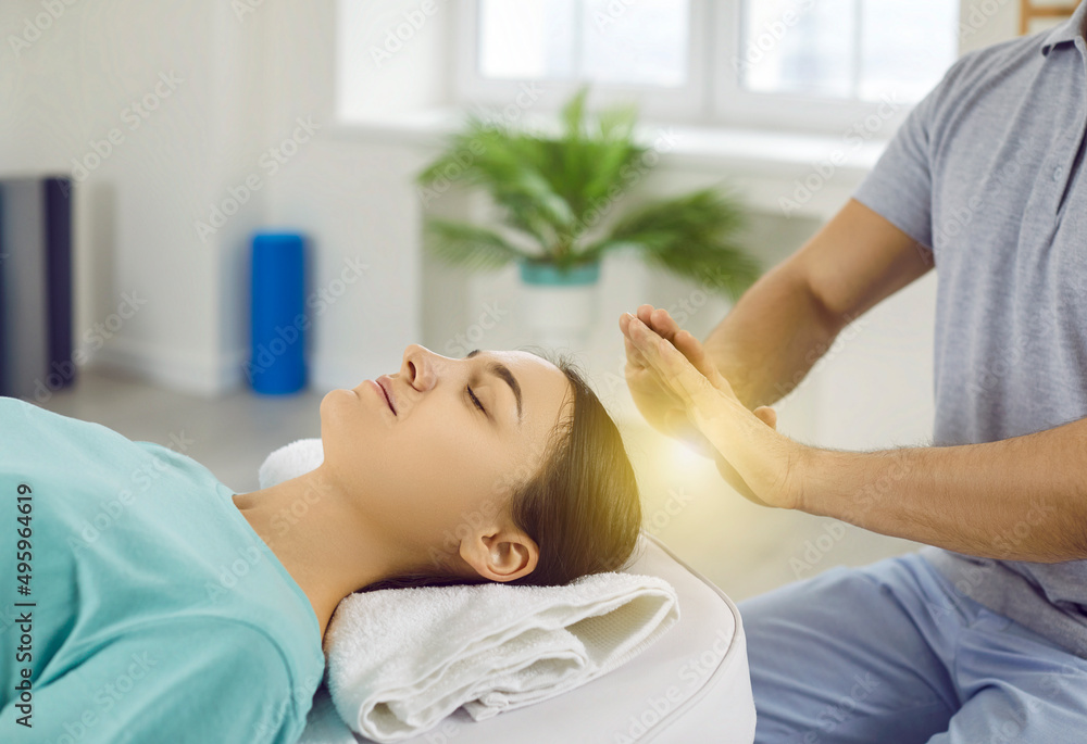 Calm beautiful woman having therapy session with professional Reiki ...
