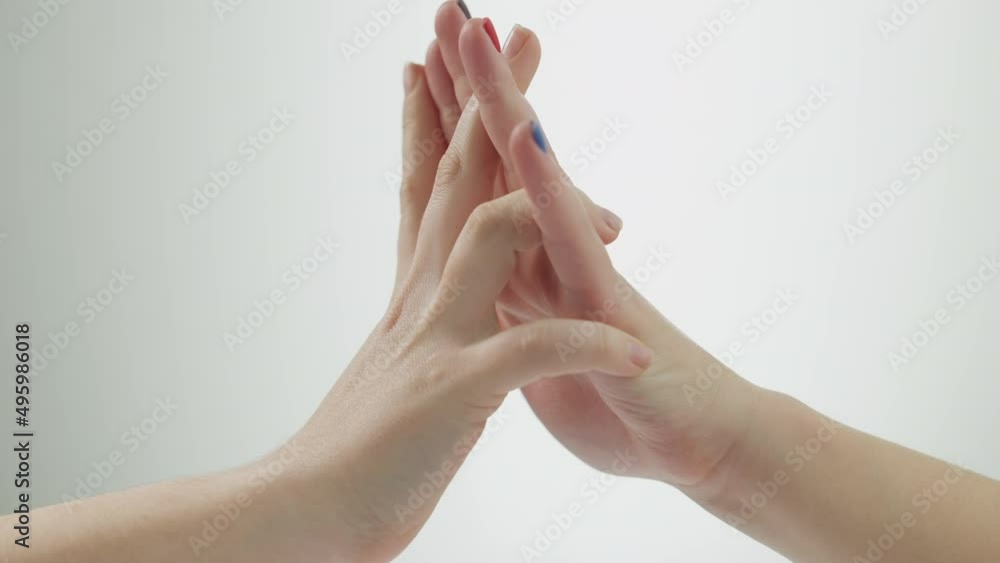 Close-up young male and female hands touching at white background ...