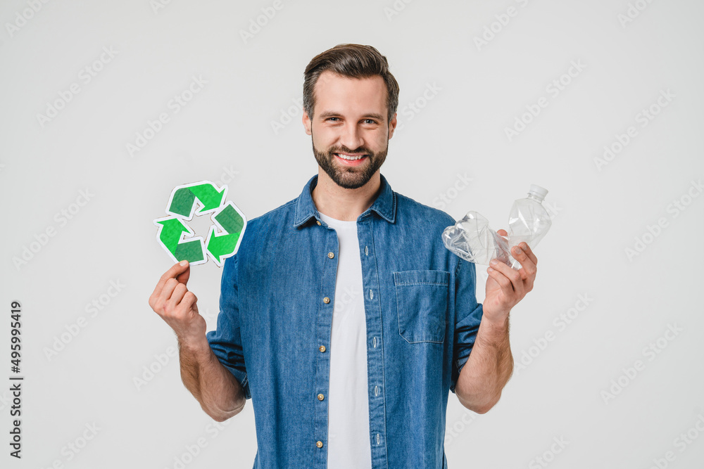 Young caucasian man eco-activist holding recycling logo sign for ...