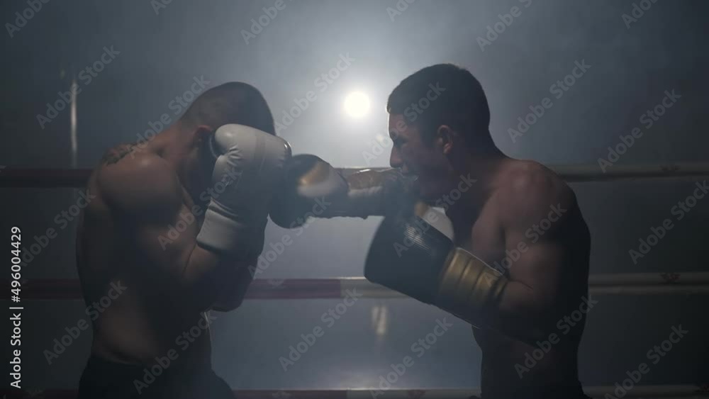 Cinematic slow motion shot of two professional young muscular shirtless ...