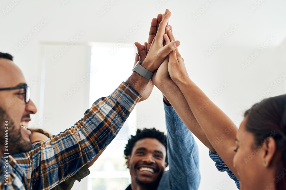 Teamwork for the win. Shot of a group of colleagues giving each other a ...