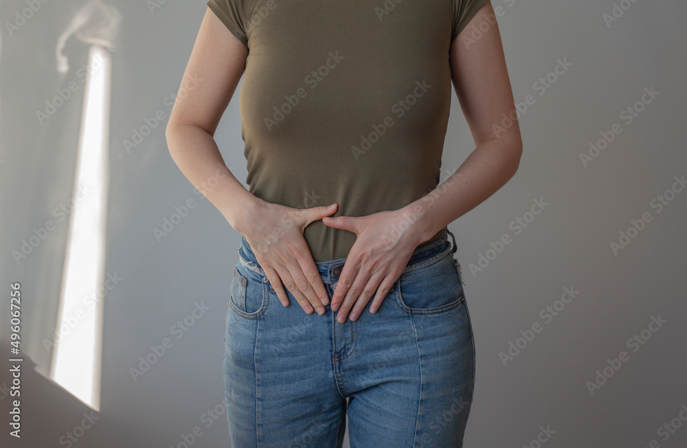 Woman bladder problem concept. Young woman holding hands on her ...