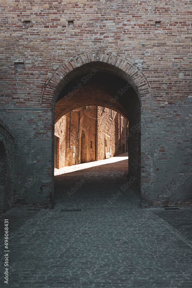 Ancient arch of a medieval wall. Entrance to an Italian village. City ...