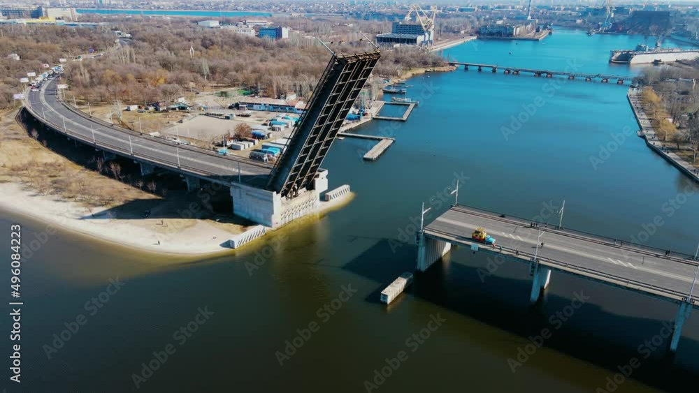 Raised drawbridge over river near ship harbor. Concept of logistics of ...