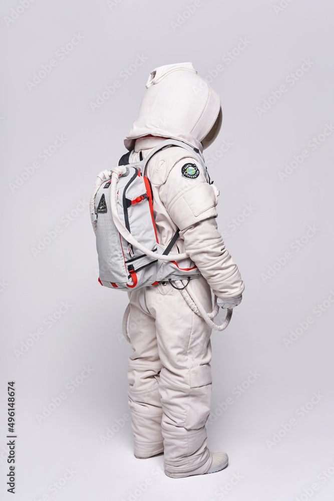 Astronaut taking off helmet of spacesuit in studio Stock Photo | Adobe ...
