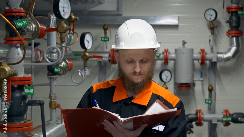 An engineer at a pumping station records pressure and temperature ...